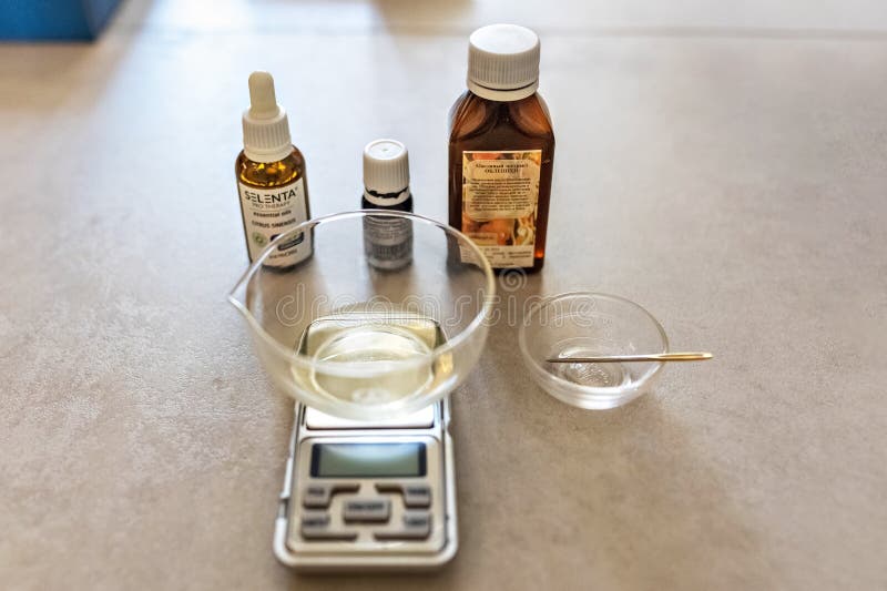 A Soap-maker Weighs Aromatic Oils for Making Cosmetics on a Kitchen ...