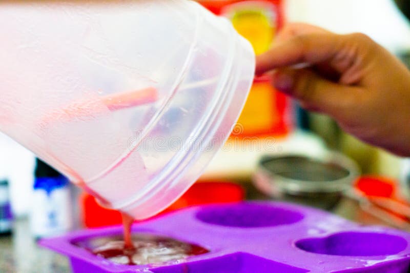 Soap Solution Being Poured from a Plastic Container into a Silicone ...
