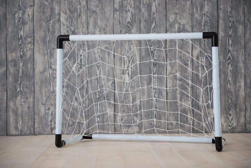 A Soccer Ball in a Small Gate on a Gray Background. Mini Football ...