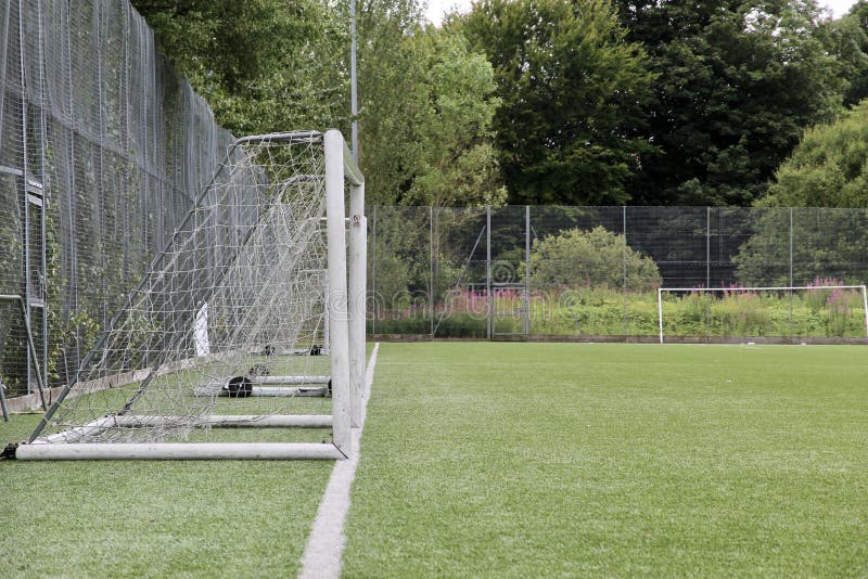 Goal Nets and Markings on a Soccer Field with Houses and Trees in the ...
