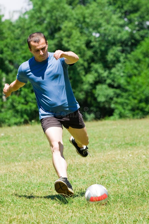 Soccer Player Kicking The Ball Stock Image - Image of ball, background ...