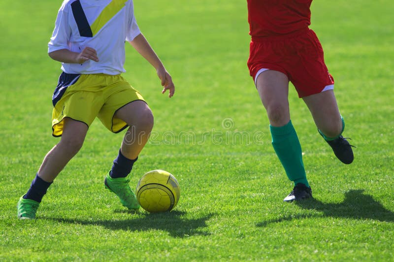 Soccer Players in a Duel on Grass Running after Soccer Ball Stock Photo ...