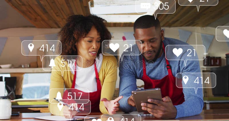 Social Media Engagement Image Over Two People in Aprons Using Tablet ...