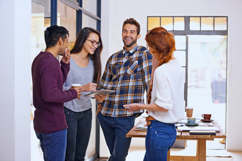 Socializing with the Team. Four Young Designers Having a Discussion in ...