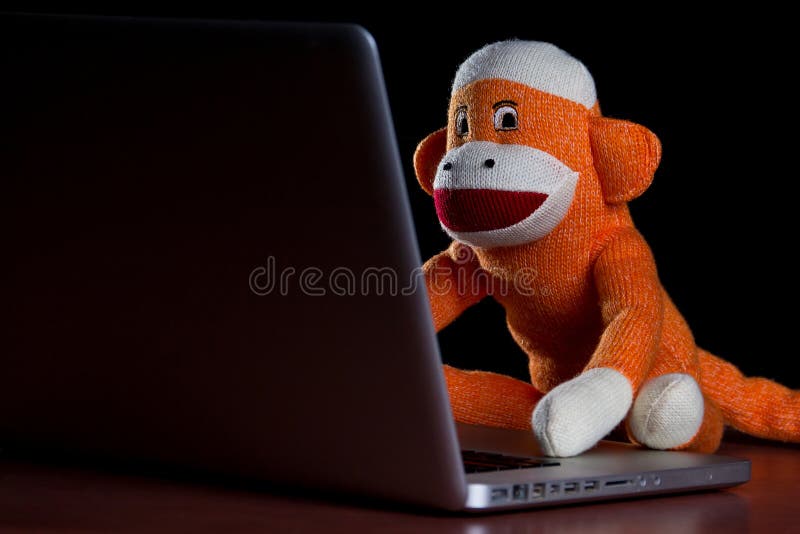 Sock Monkey Using a Computer Stock Image - Image of night, monkey: 75924717