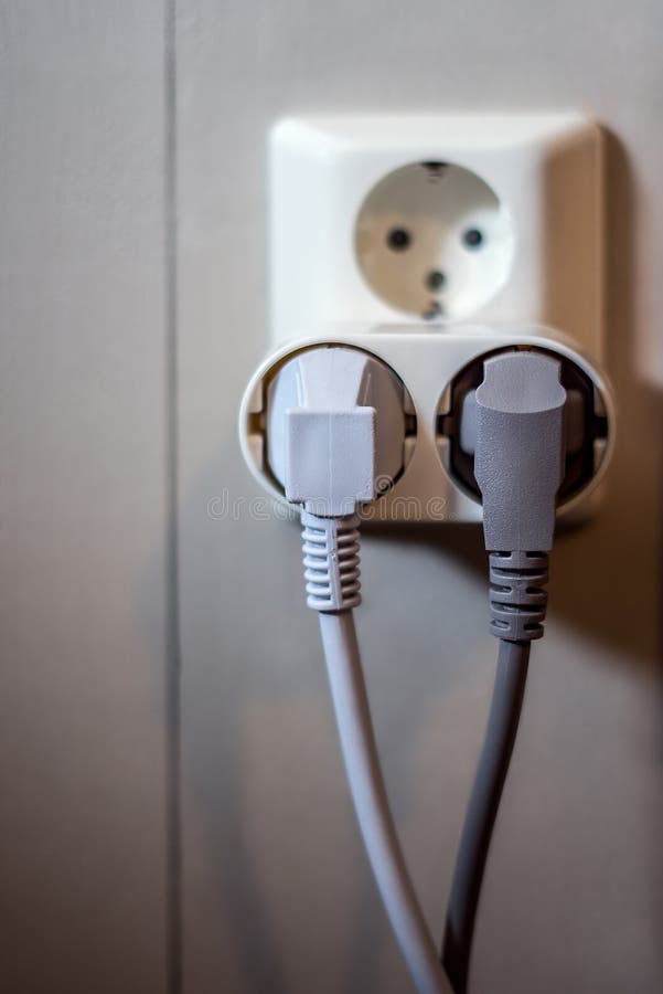 Socket on Wall with Two Pluged Electrical Outlets and Powercords Stock ...