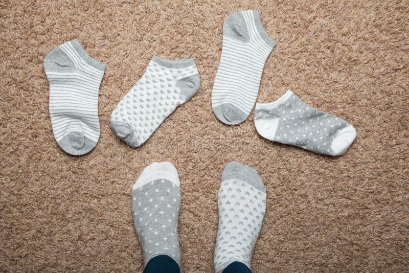 Scattered Socks On The Floor In The House, The Woman Chooses What To ...