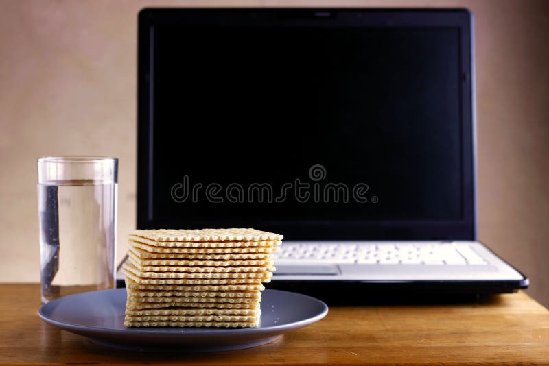 Soda Crackers, Glass of Water and a Computer Stock Image - Image of ...
