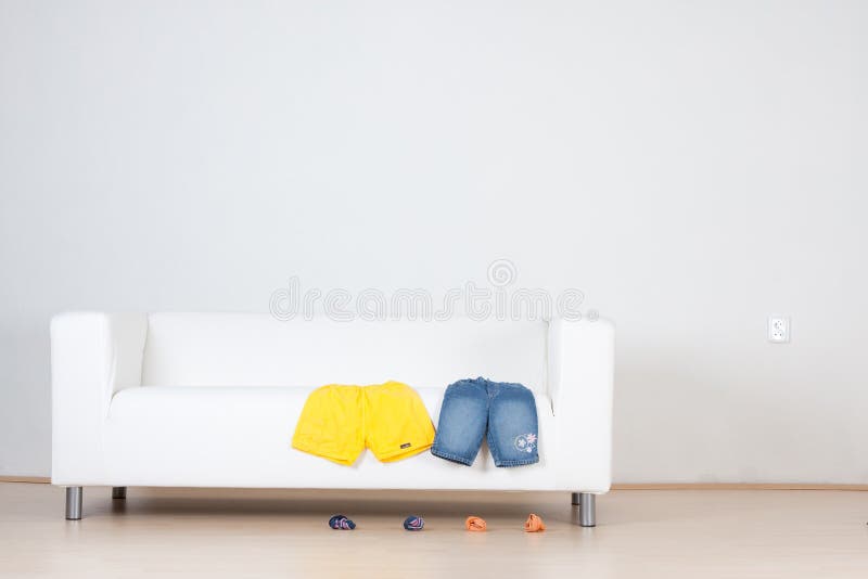 Sofa with Clothes and Shoes Stock Photo - Image of couch, colors: 11545276