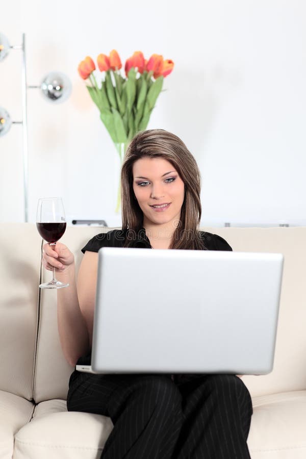 On Sofa with Computer and Wine Glass Stock Photo - Image of model ...