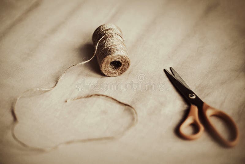 On the Soft Beige Fabric There are Scissors and a Skein of Strong Hemp ...