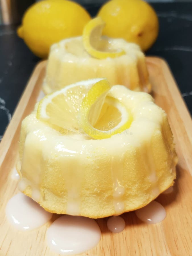 Soft Butter Cake Topped with Lemon Sauce and Lemon Wedges. Stock Photo ...