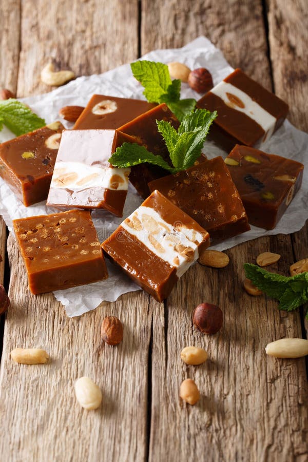 Soft Caramel Candy with Nuts Decorated with Mint Closeup. Vertical ...