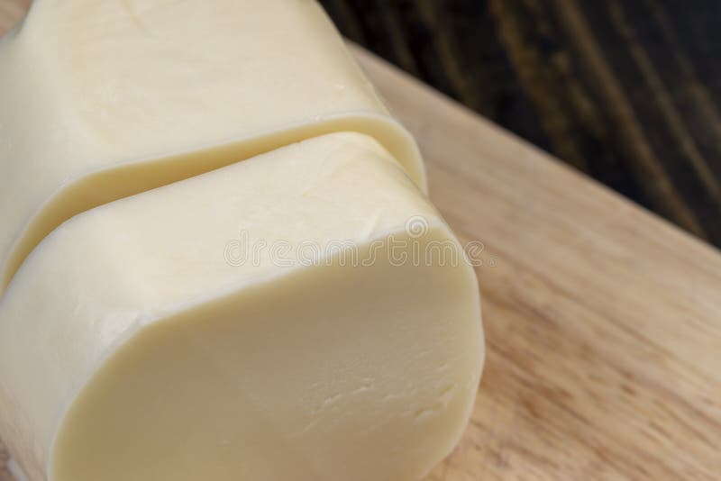 Soft Cheese Sliced into Thick Chunks on a Cutting Board Stock Photo ...