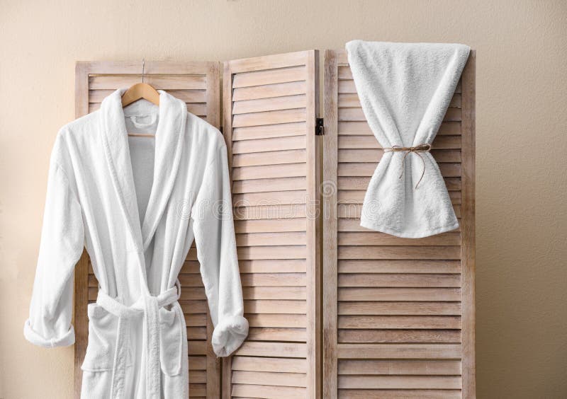 Soft Comfortable Bathrobe Hanging on Folding Screen in Room Interior ...