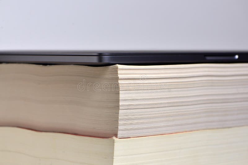 Laptop Computer Stacked upon Thick Soft Cover Book Stock Image - Image ...