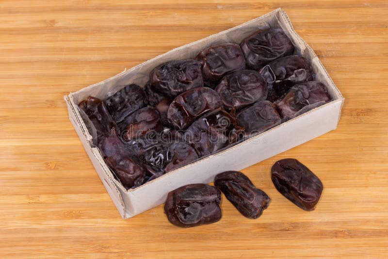 Soft Date Fruits in Cardboard Box on a Wooden Surface Stock Photo ...