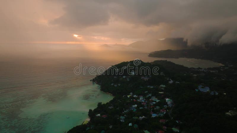Soft Evening Light Over Ocean Waves with Mountain Silhouettes ...