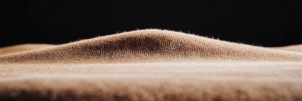Soft Fabric Forms a Gentle Mound Under Focused Lighting in a Dark ...