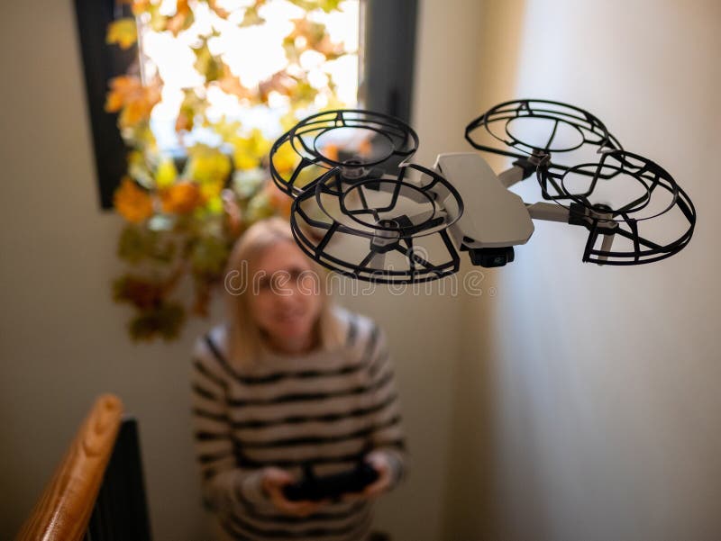 Soft Focus of a Drone Controlled by a Woman, Inside a House Stock Photo ...