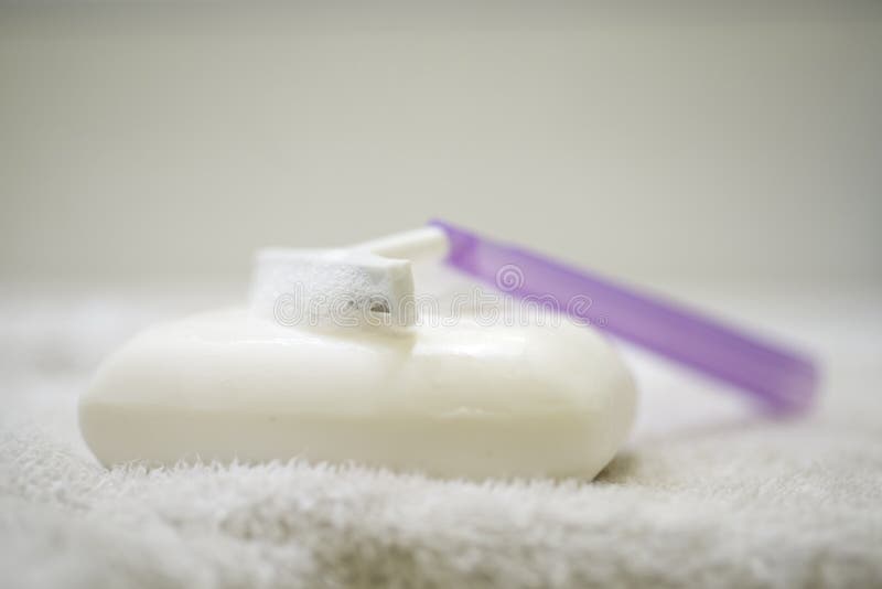 Soft Focus of a Purple Razor on a Bar of Soap on a Towel Stock Photo ...