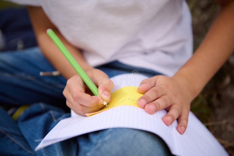 Soft Focus on Schoolboy Hands Holding a Pen and Doing Homework, Writing ...