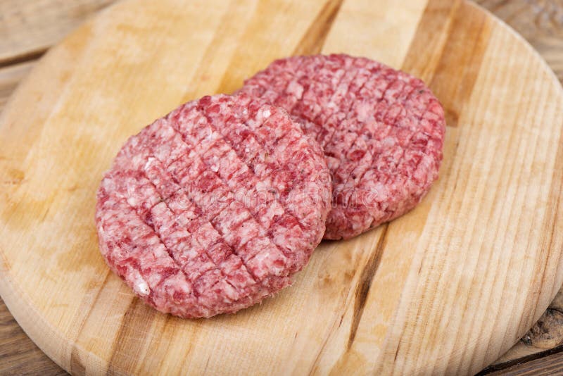 Soft Focus. Two Raw Pink Beef Cutlets on a Cutting Board Stock Photo ...