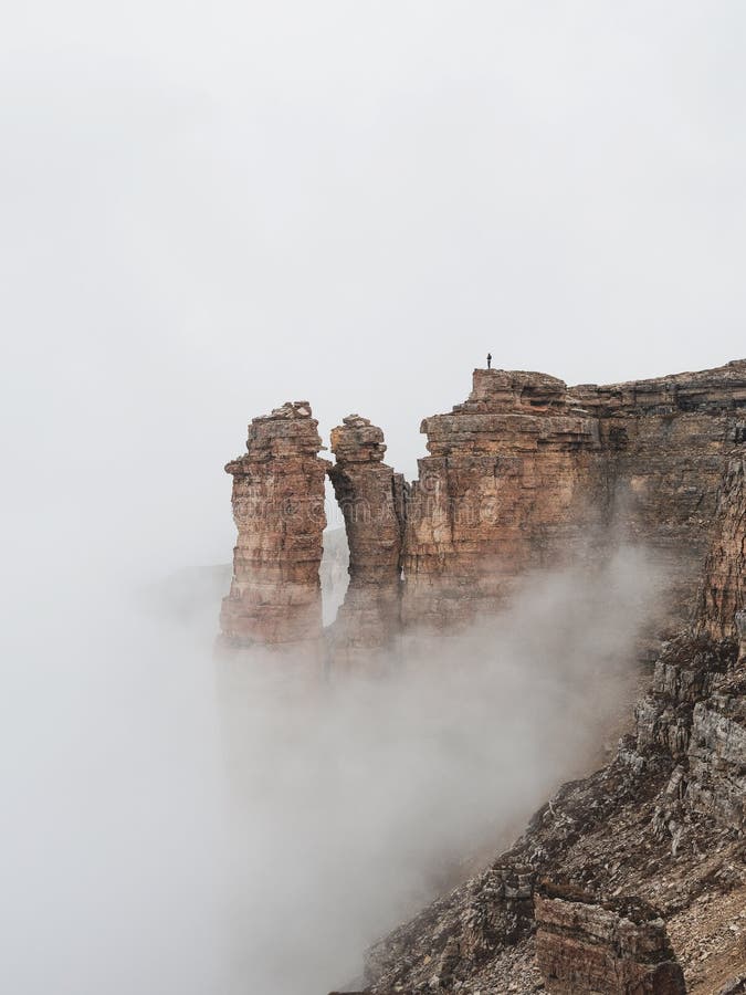 Vertical View of Sharp Rocks in the Fog. Mountains in a Dense Fog Stock ...