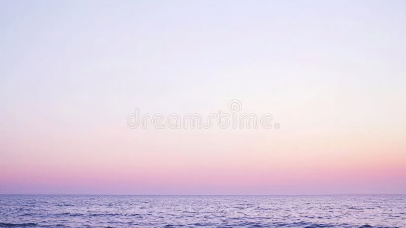 A Soft, Pastel Pink and Purple Sunset Over a Calm Ocean Stock Photo ...