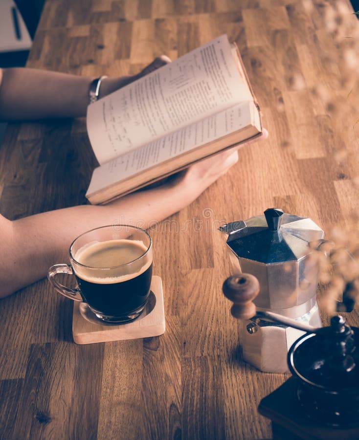 Young Girl Reading a Book and Drinking Coffee Stock Image - Image of ...