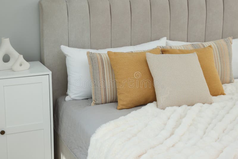 Different Soft Pillows on Bed in Room Stock Photo - Image of cozy ...