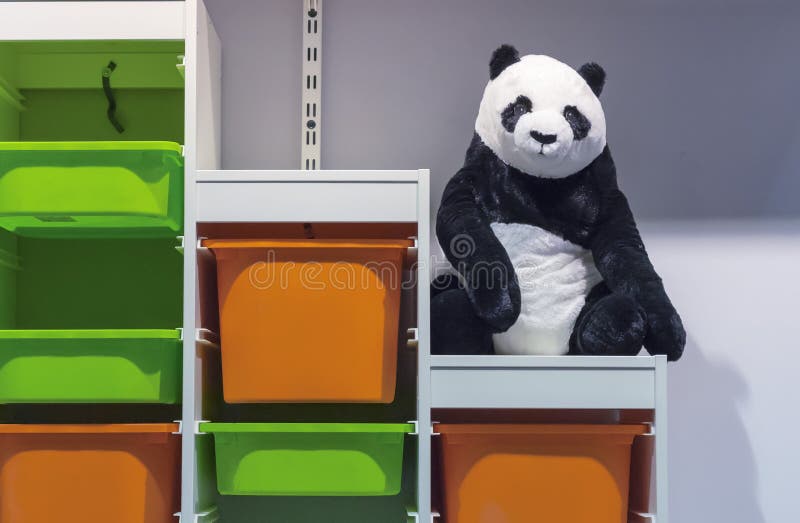 Soft Toy Panda on the Rack with Colored Plastic Boxes Stock Image ...