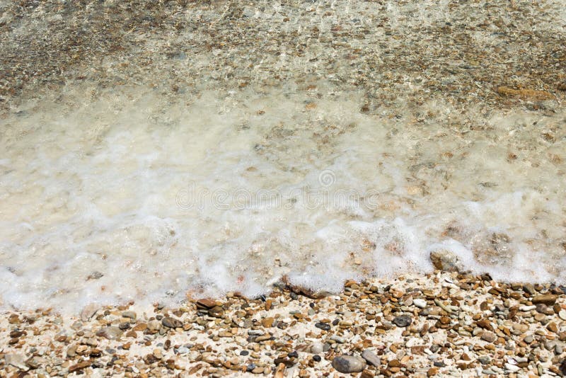 Soft Waves with Foam of Water on Pebbles and Sandy Beach Stock Photo ...