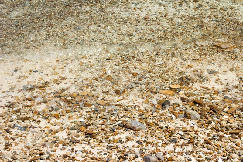 Soft Waves with Foam of Water on Pebbles and Sandy Beach Stock Photo ...