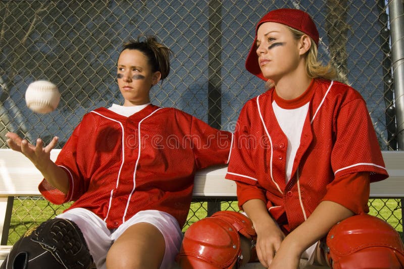Softball Players Sitting on Bench Stock Photo - Image of mates ...