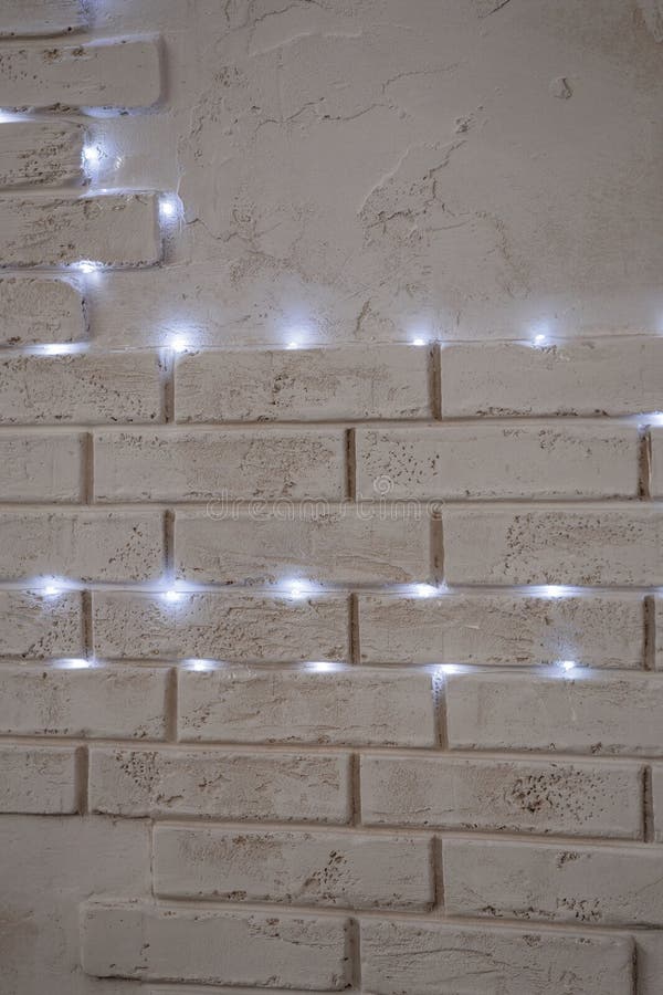 Softly Glowing LED String Lights Against Rustic White Brick Wall Stock ...