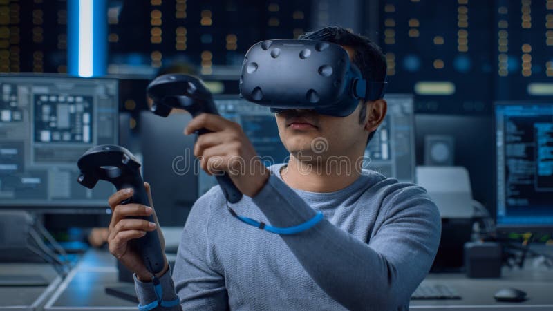 Software Delevoper Wearing Virtual Reality Headset Using Controllers To Develop and Program VR ...