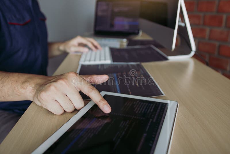 Software Developer Is Pointing To The Paper Working And Analyzing Together The Code Written Into