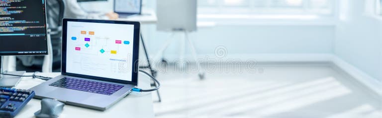 Software Developer Reviews UX UI Design Diagrams while Coding at a ...