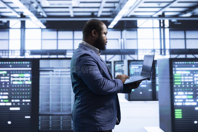 Software Developer in Server Room Using Laptop To Implement Security ...