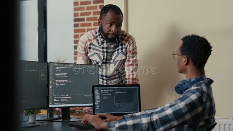 Software Developer Sitting at Desk with Multiple Screens and Laptop ...