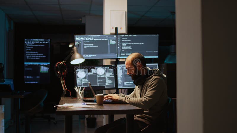 Software Developer Typing Source Code On Laptop And Multiple Monitors
