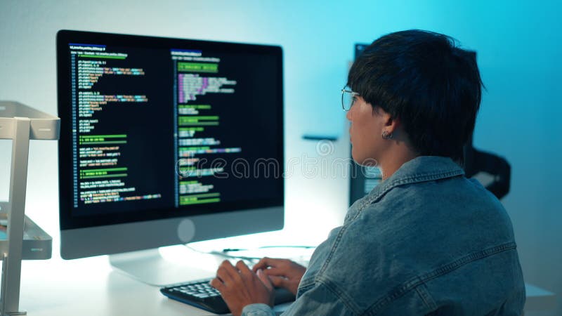 Software Developer Pointing At Monitor Debugging Code Identifying Issue In Application