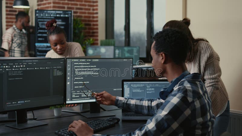 Programmer Analyzing Compiling Code On Multiple Screens Takes Off Glasses And Doing High Five