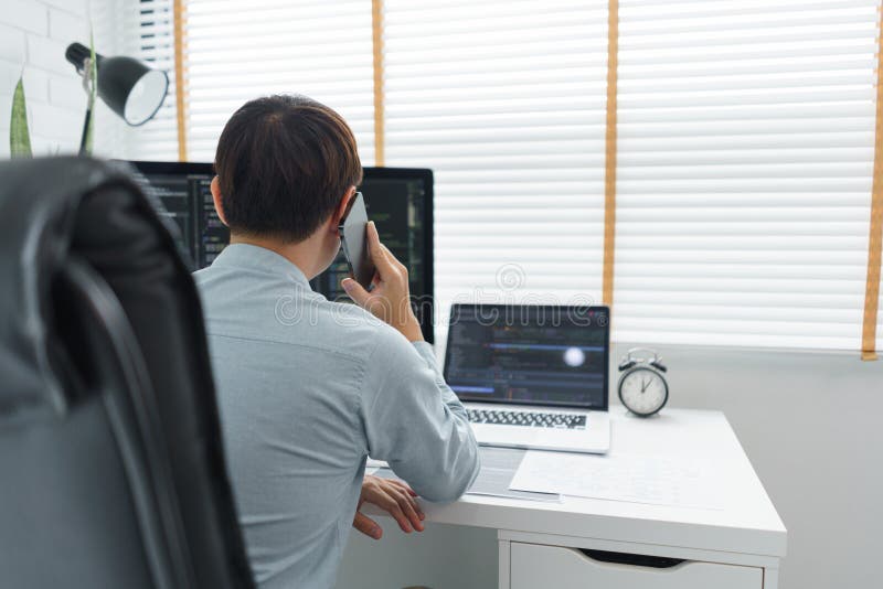 Software Development Concept, Male Programmer Talking on Smartphone and ... Software Development Concept, Male Programmer Talking on Smartphone and ...