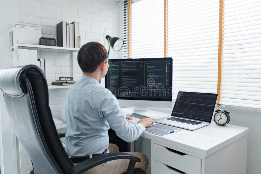 Software Development Concept, Male Programmer Typing Data Code and Working on Multiple Screens ...