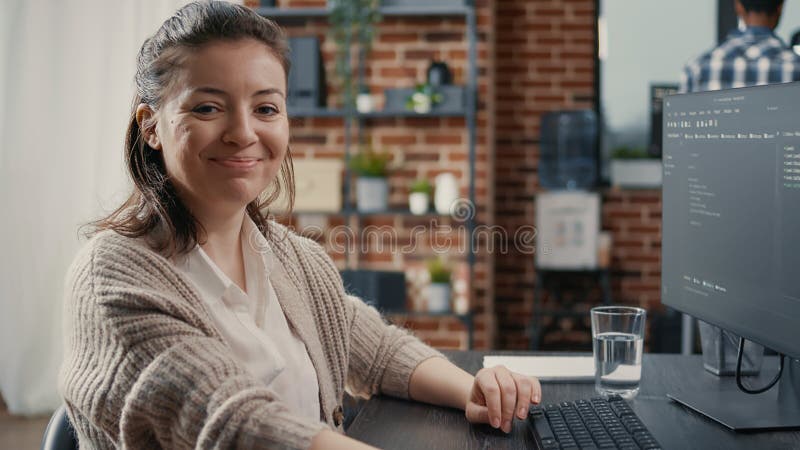 Software Engineer Typing Source Code On Computer Keyboard Turning Head And Smiling Stock Image