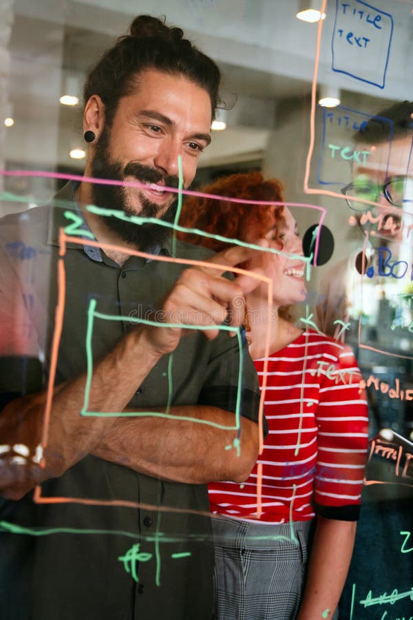 Software Engineers Working Together on Project at Tech Startup. Business Designers Working ...