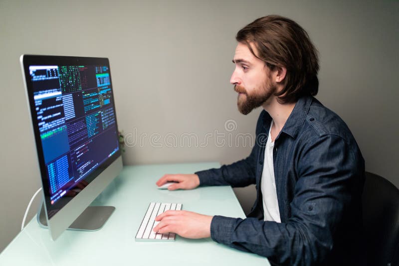 Software Man Developer on the Computer Screen and is Analyzing the Code ...