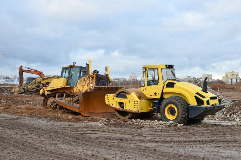 Soil Compactor and Bulldozer at Construction Site Stock Image - Image ...